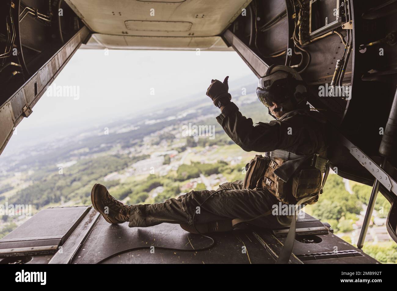 U.S. Marine Corps Cpl. Ryan Caffrey, an MV-22B Osprey crew chief with ...