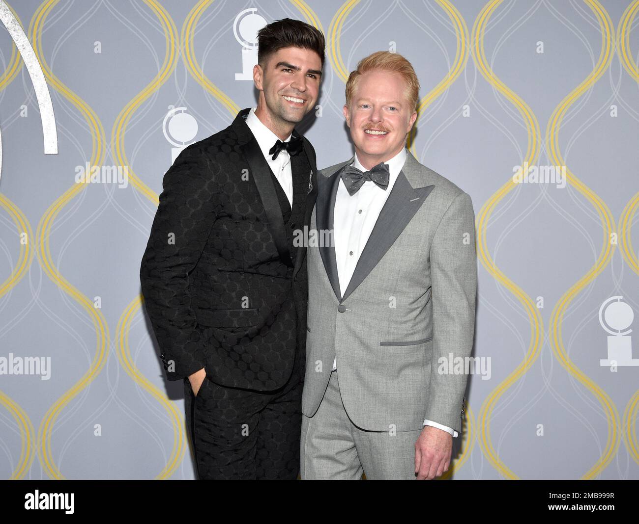 Justin Mikita, left, and Jesse Tyler Ferguson arrive at the 75th annual ...