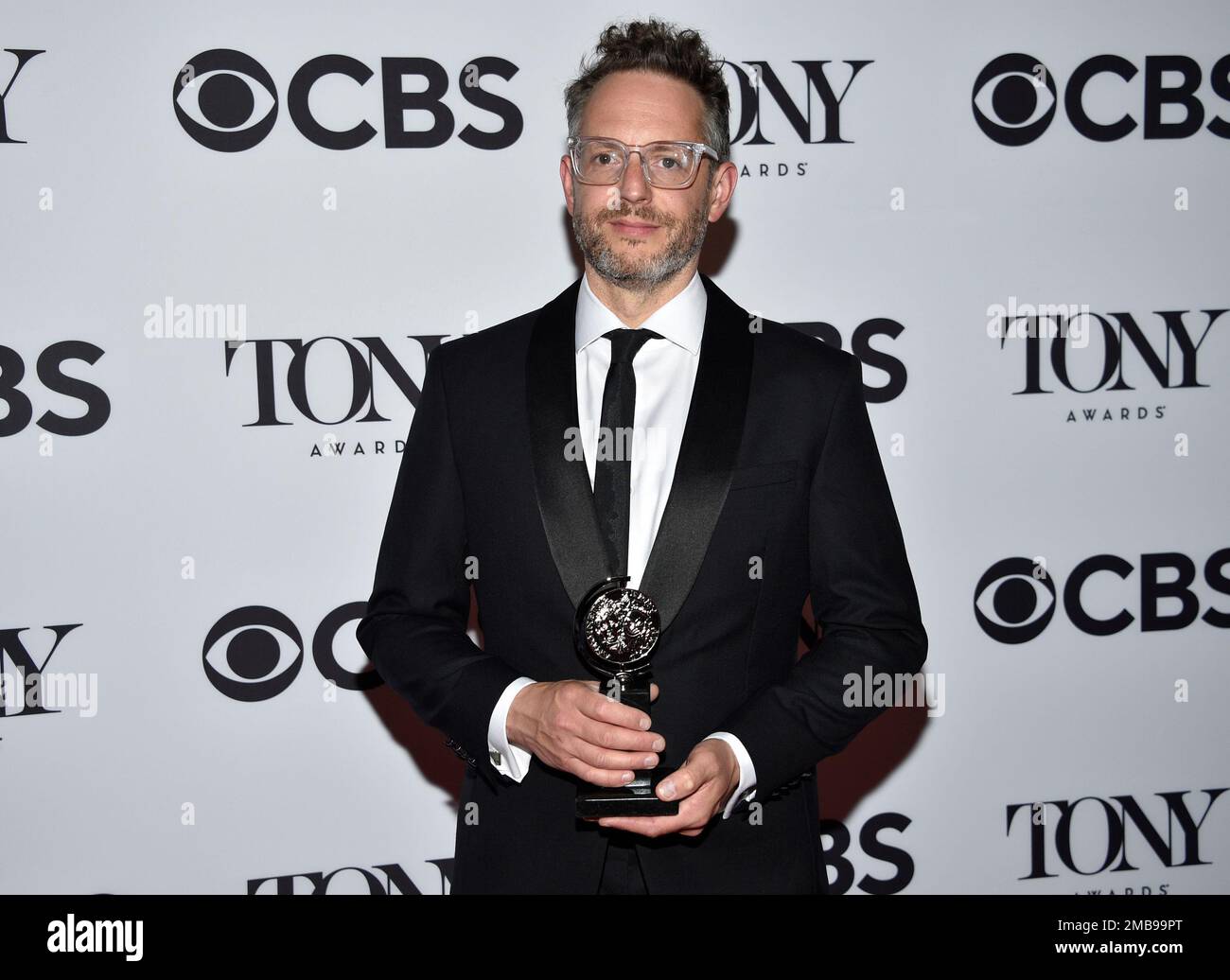Jon Clark poses in the press room with the award for best lighting ...