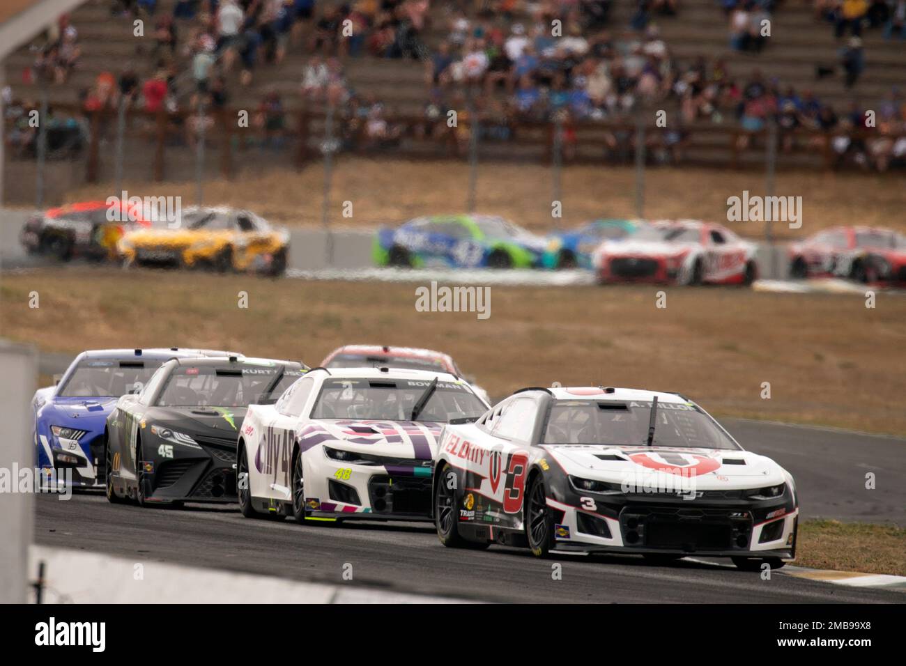 Cars navigate the turns during a NASCAR Cup Series auto race, Sunday ...