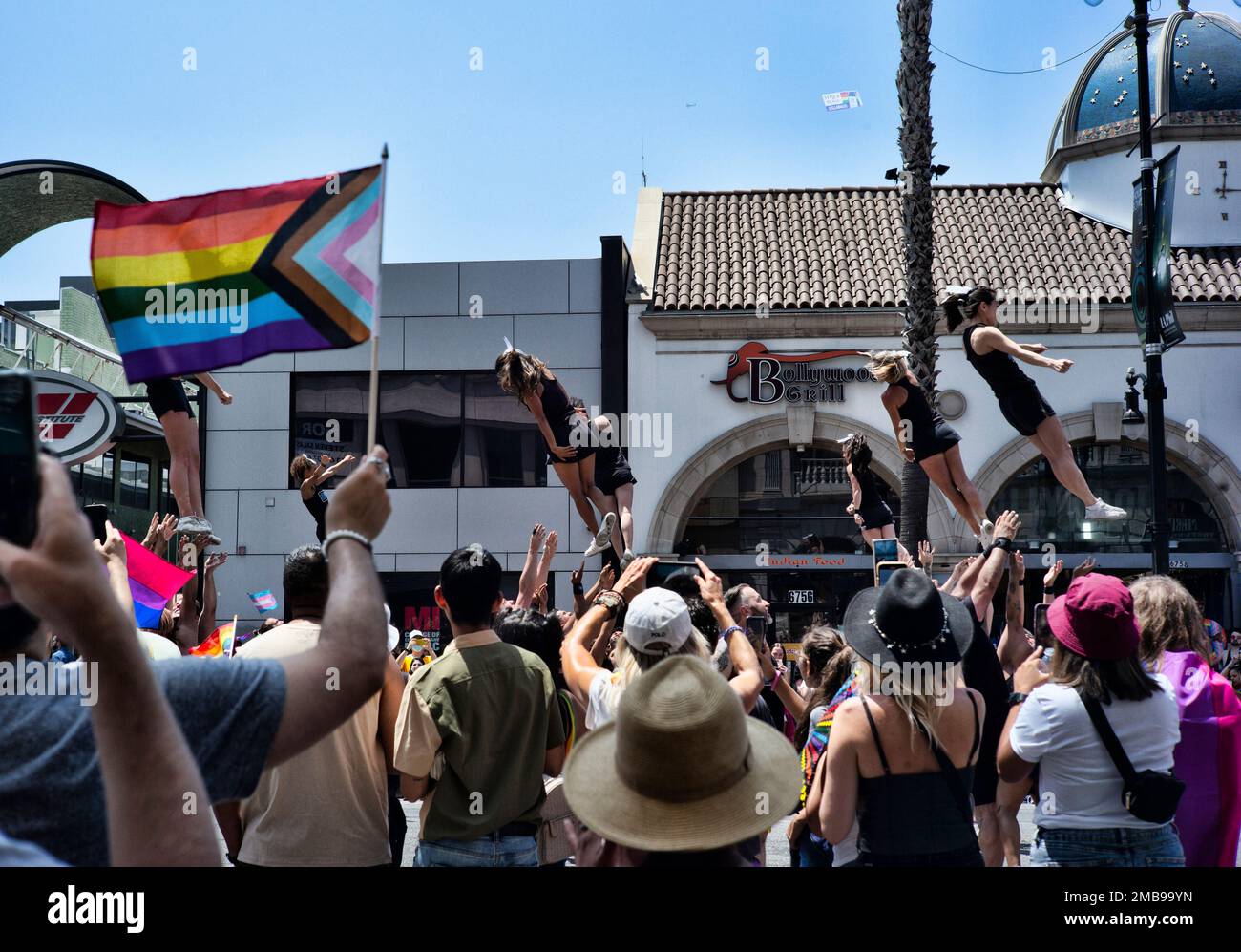 An acrobatic team performs along Hollywood Blvd. during the LA Pride ...