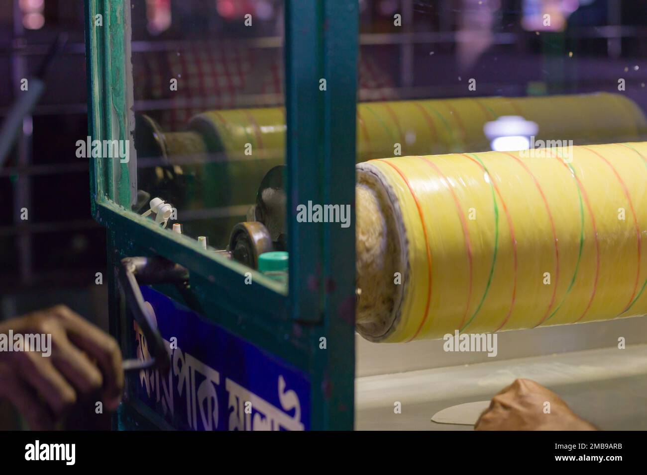roller kulfi or ice cream roller being made by hand. cream cheese ice ...