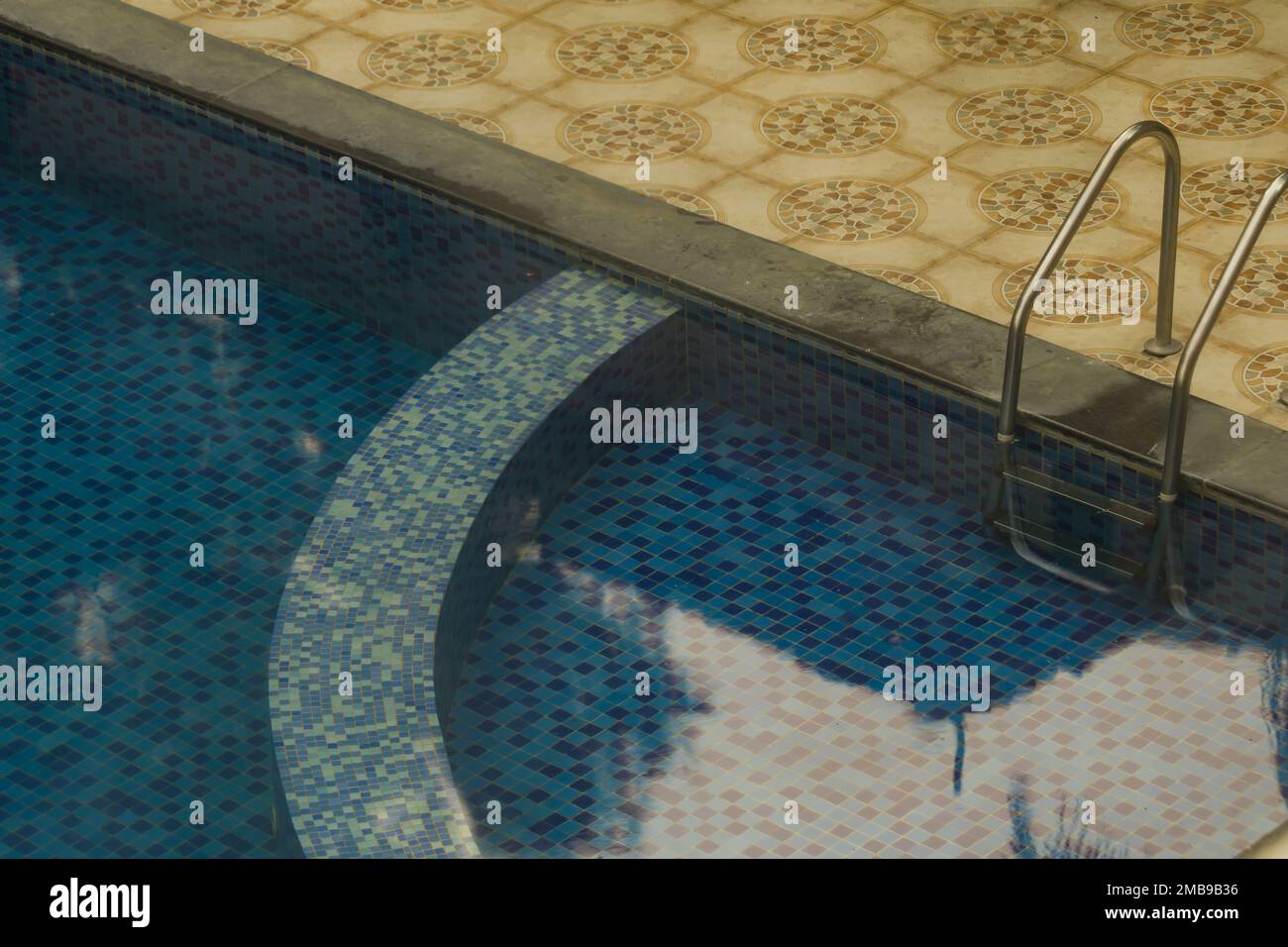 clear water of kids swimming pool. blue colored bottom of the pool is ...