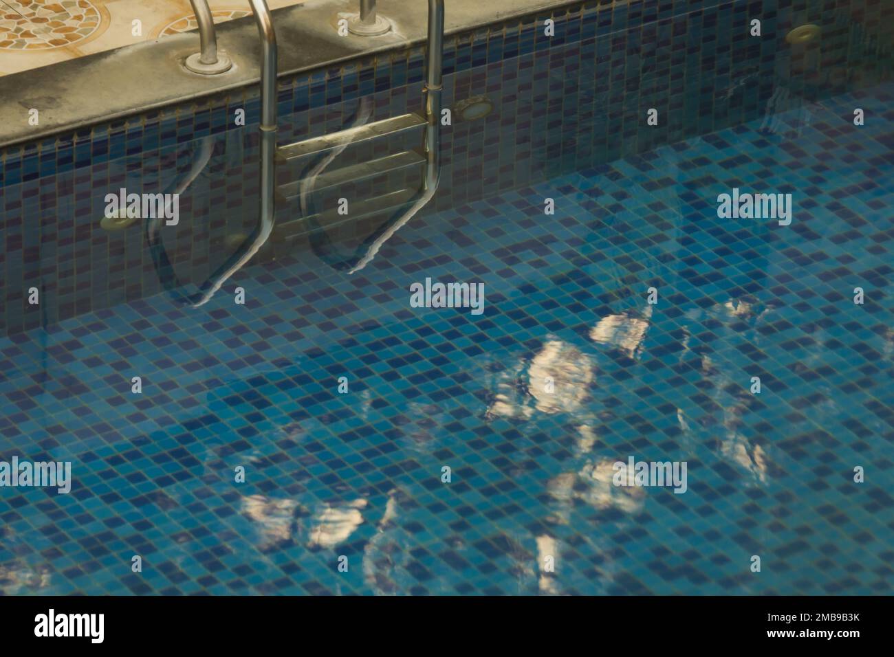 clear water of swimming pool. blue colored bottom of the pool is ...