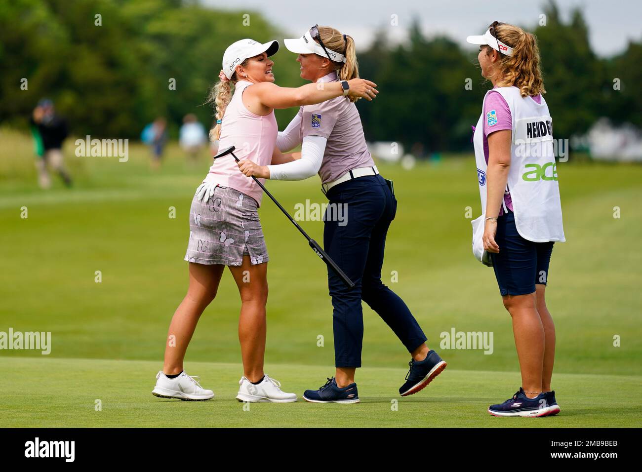 Brooke M. Henderson, of Canada, center, gets a hug from Lindsey Weaver ...