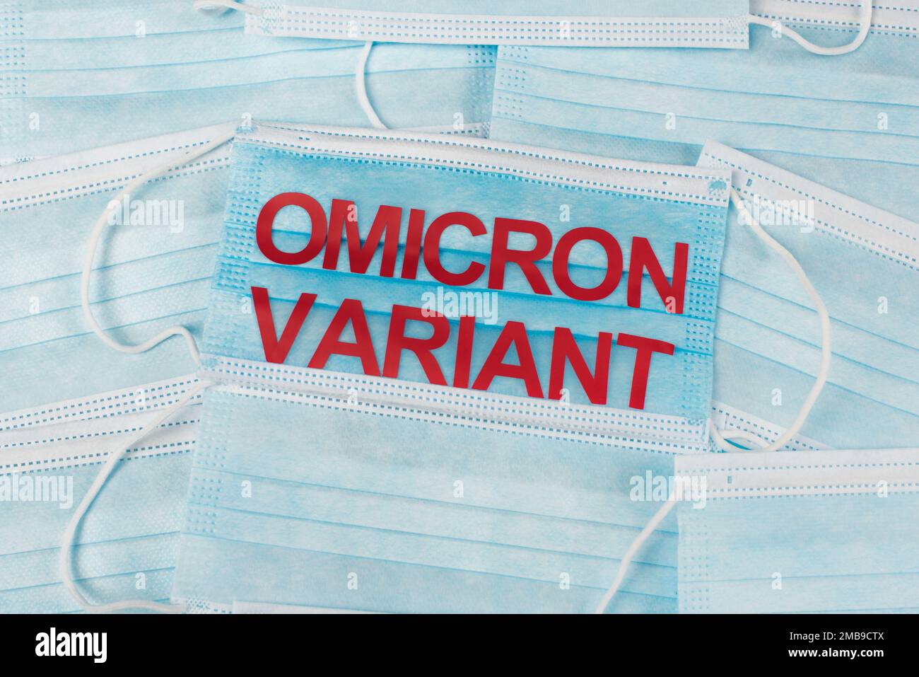 Top view of medical masks with red omicron variant lettering,stock ...