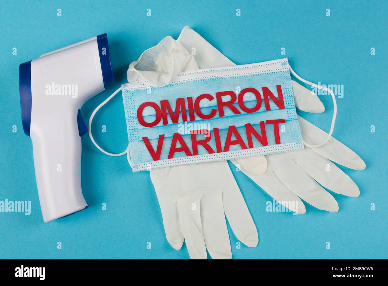 Top view of medical mask with omicron variant lettering near latex ...
