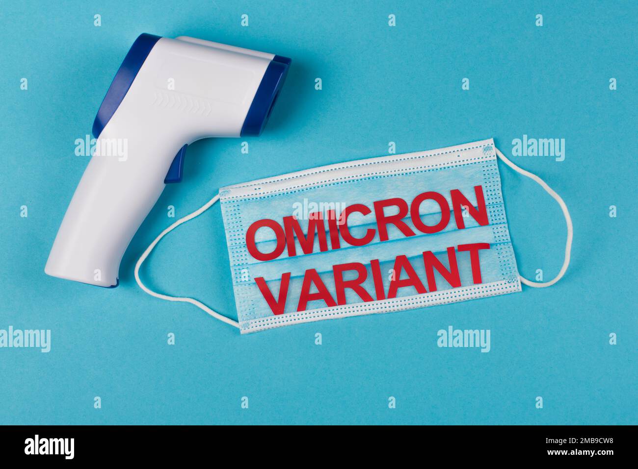 Top view of non-contact pyrometer near medical mask with omicron ...