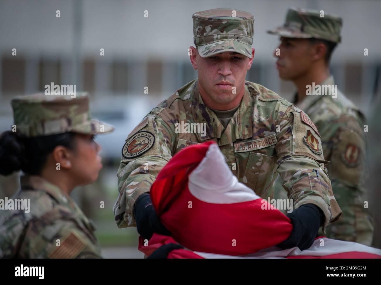 Tech. Sgt. Jerry Tamayo, 96th Medical Group, folds the base flag to be ...