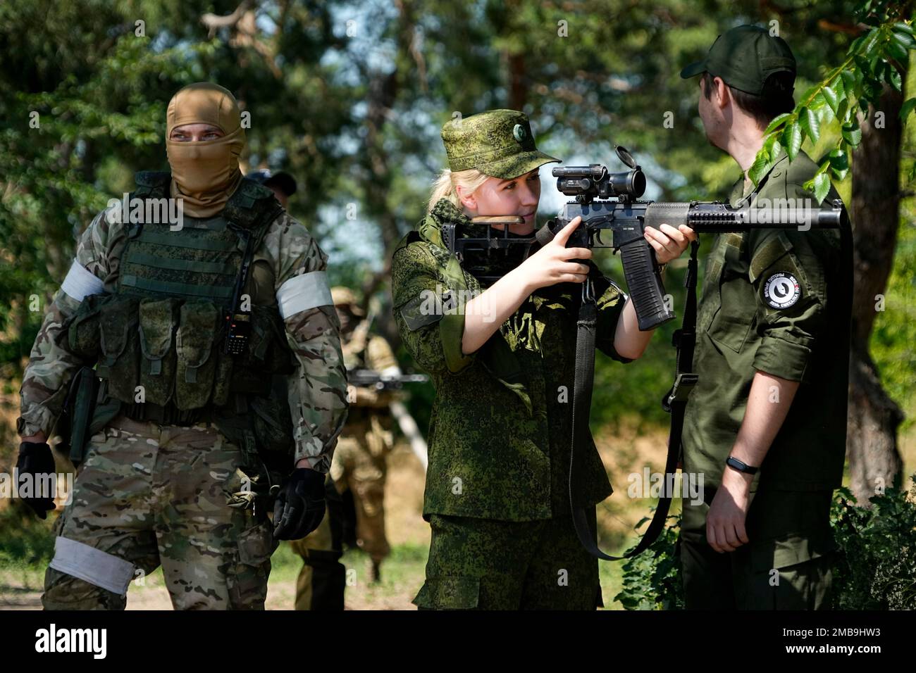 A Russian Army soldier looks through a sniper rifle scope as she and ...