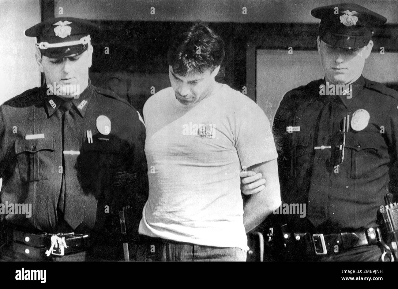 FILE - Peter Dushame, 33, of North Andover, Mass., center, is lead out ...