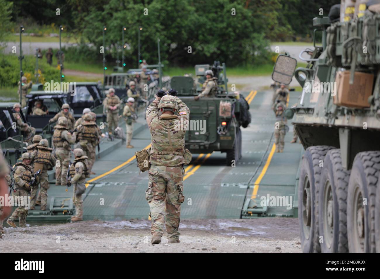 Strykers use a ground guide from the nearside to board a hasty bridge ...