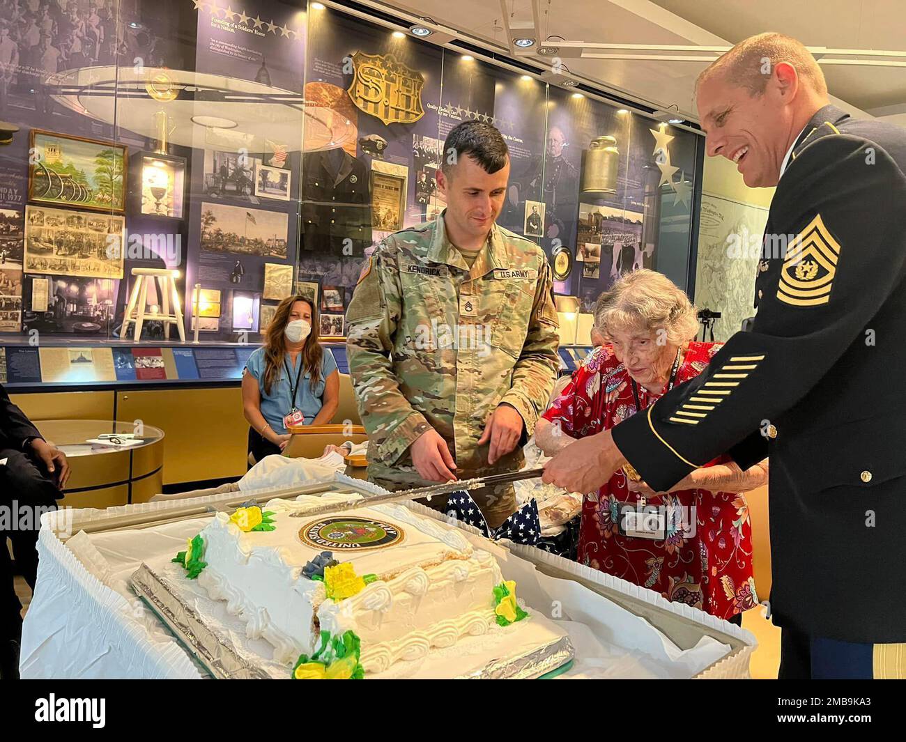 Army National Guard Command Sgt. Maj. John T. Raines cut the cake with ...