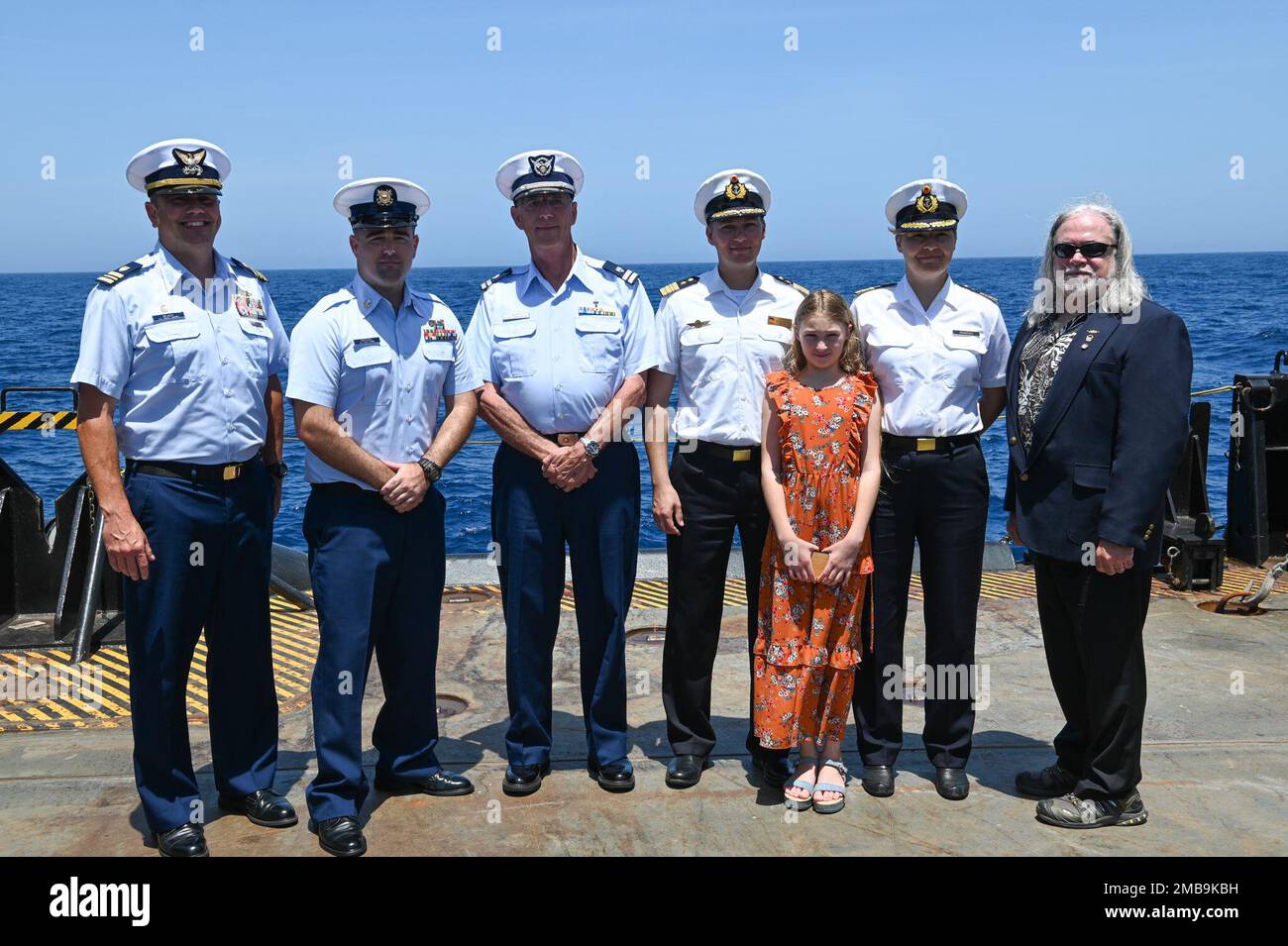 Coast Guard Cutter crew members pose for a picture with Commander ...