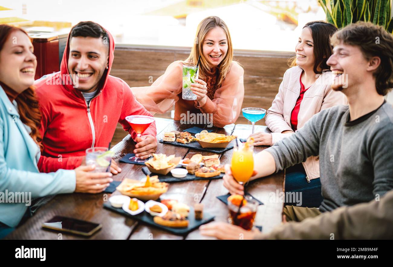 Trendy friends sharing multicolored drinks - Young people having fun ...