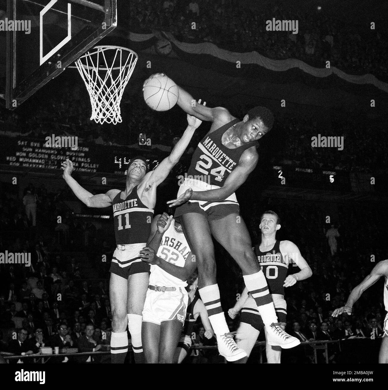 FILE - Teammates George Thompson (24) and Pat Smith (11) of Marquette ...