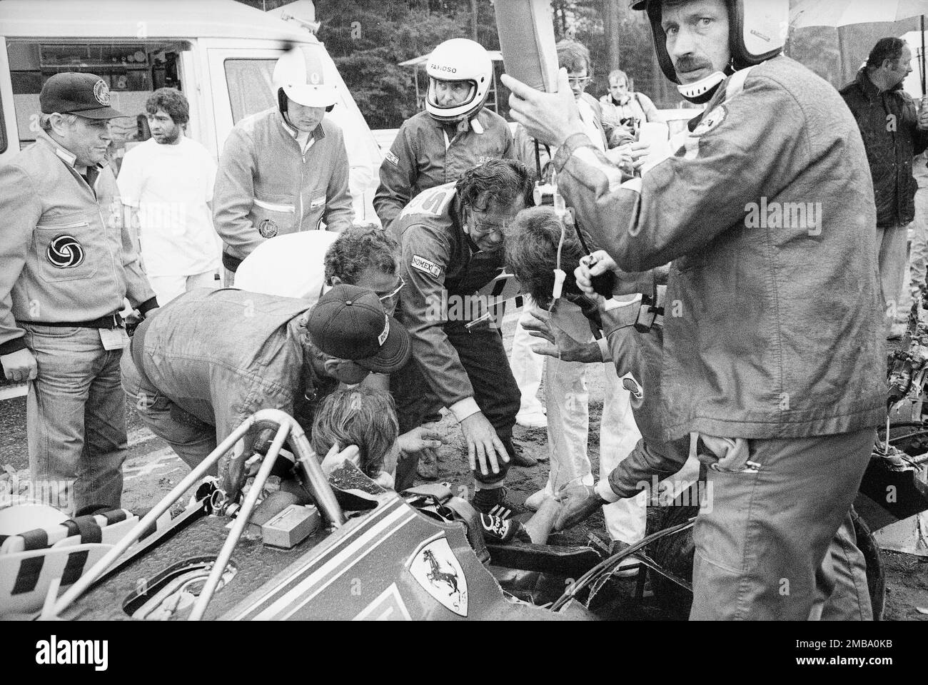 French driver Didier Pironi, back to camera, sits in his damaged ...
