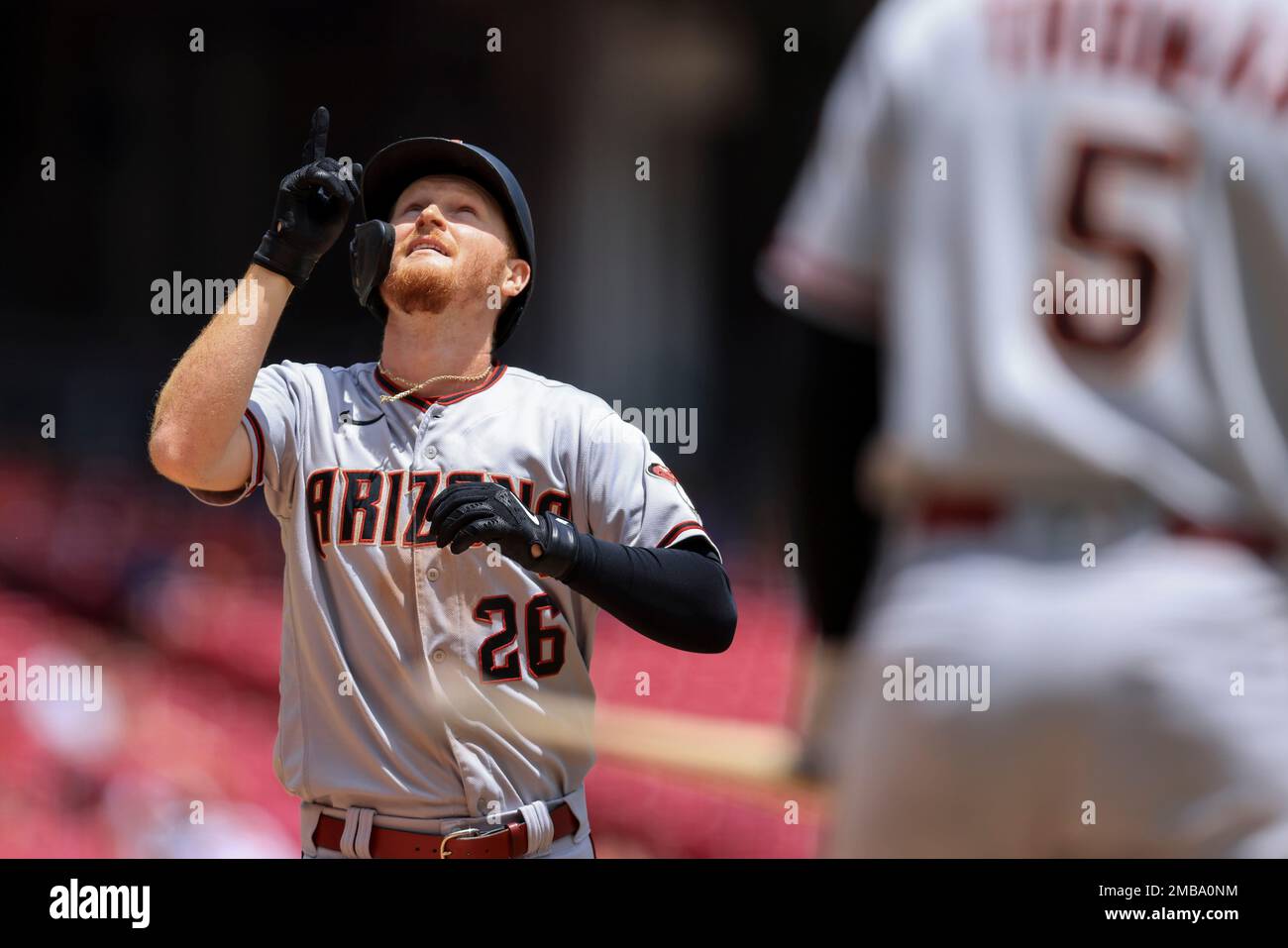 Arizona Diamondbacks' Pavin Smith points skyward as he crosses home ...