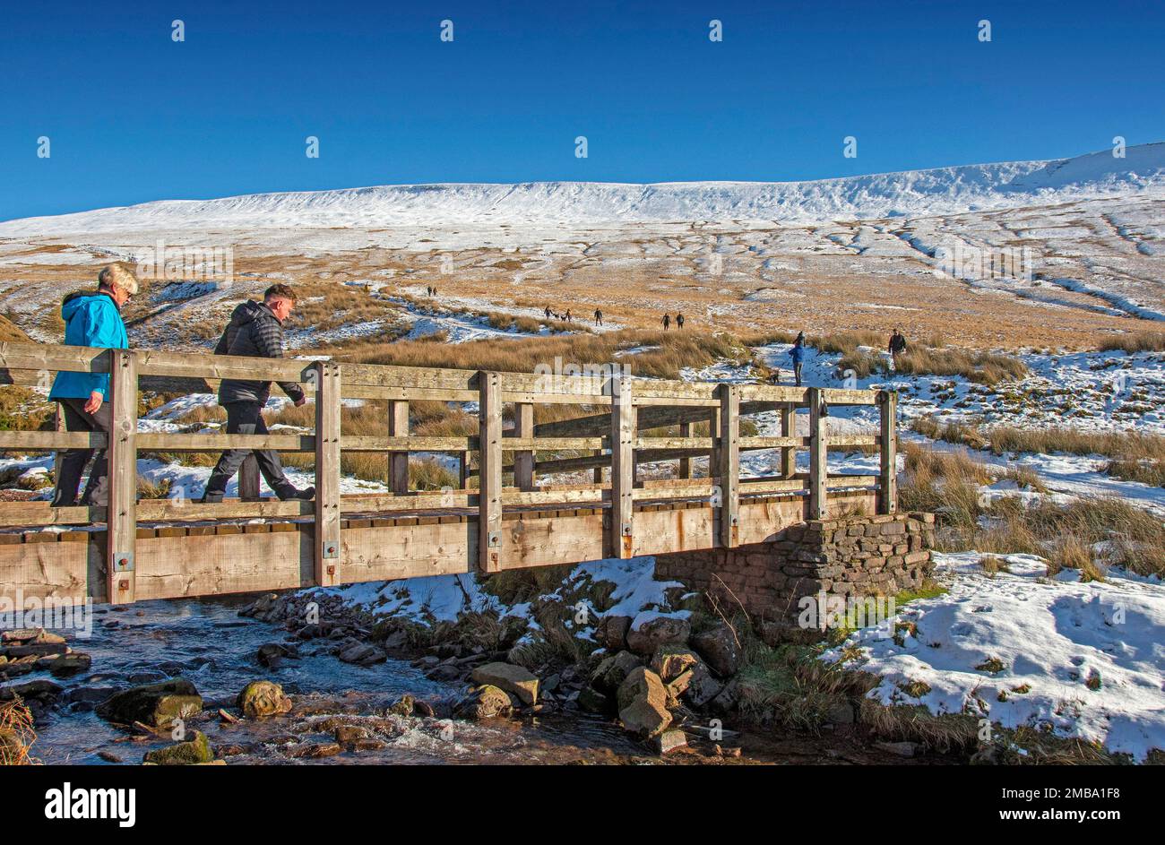 Brecon, UK. 20th Jan, 2023. People make their way across wooden ...