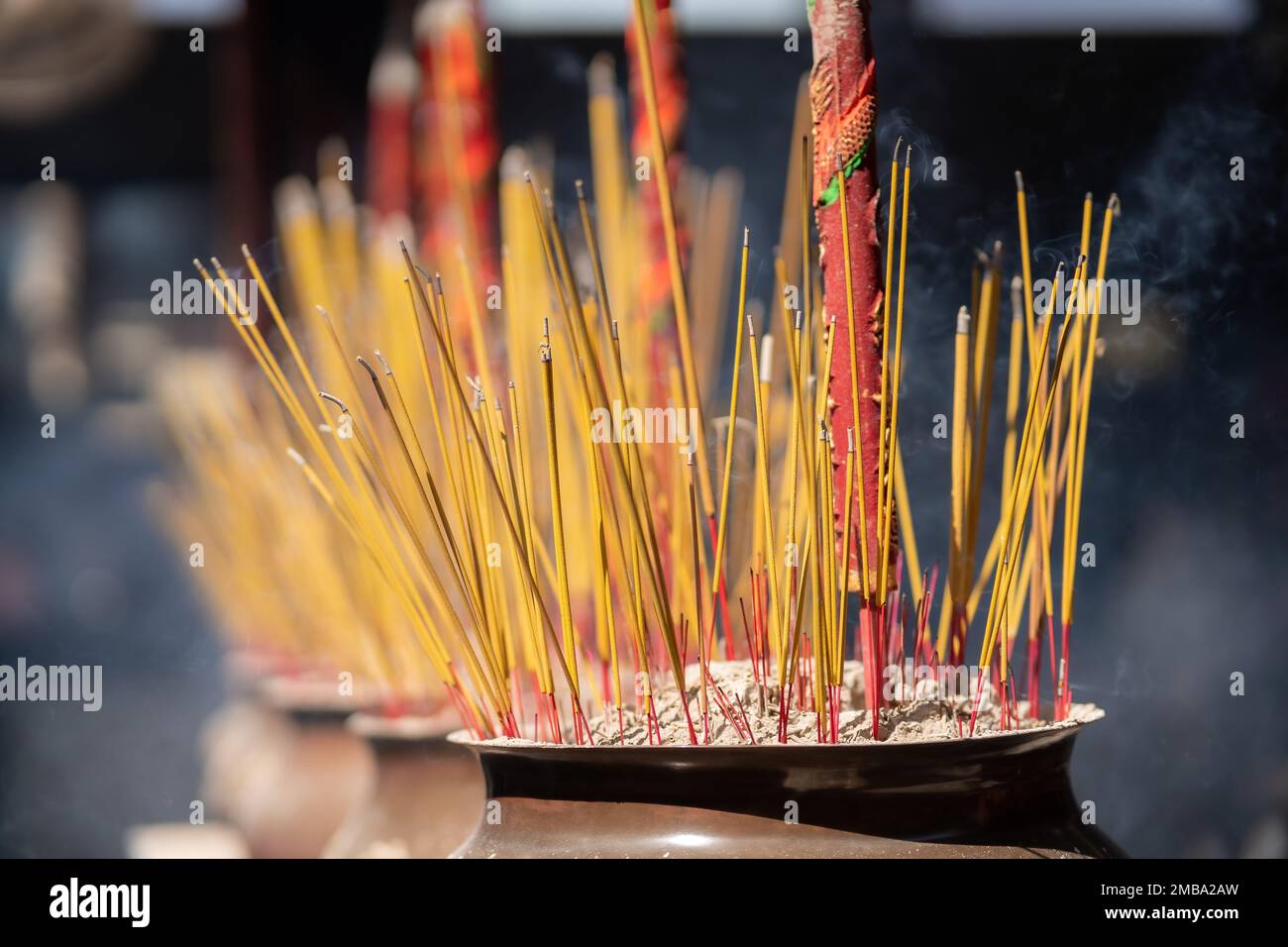 Close up of burning incense sticks on the doors of temples in Vietnam ...