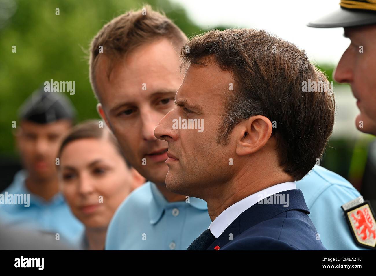 French President Emmanuel Macron listens to an officer during a visit ...