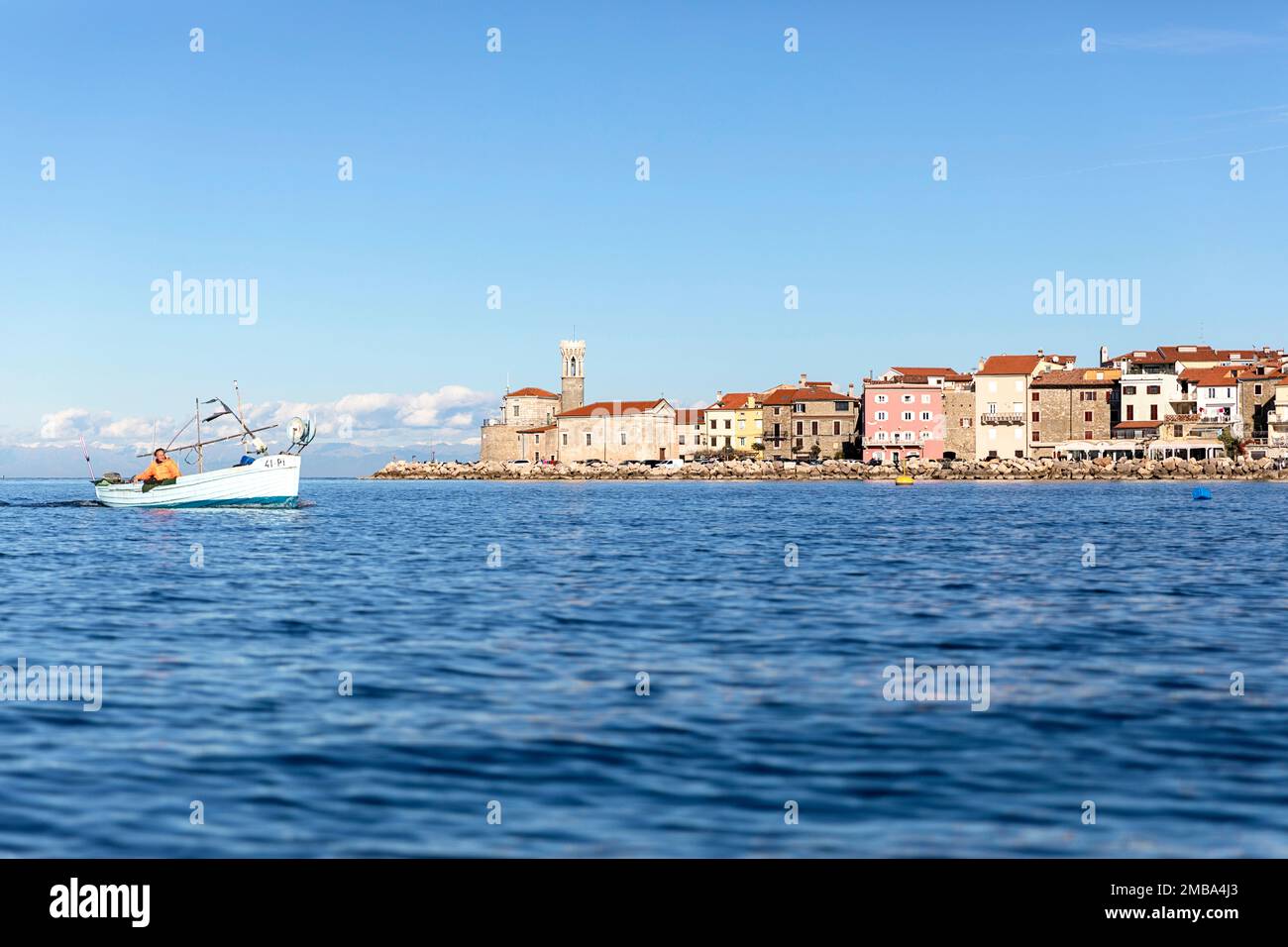 Local fisherman in a traditional wooden boat returning to the fishing ...