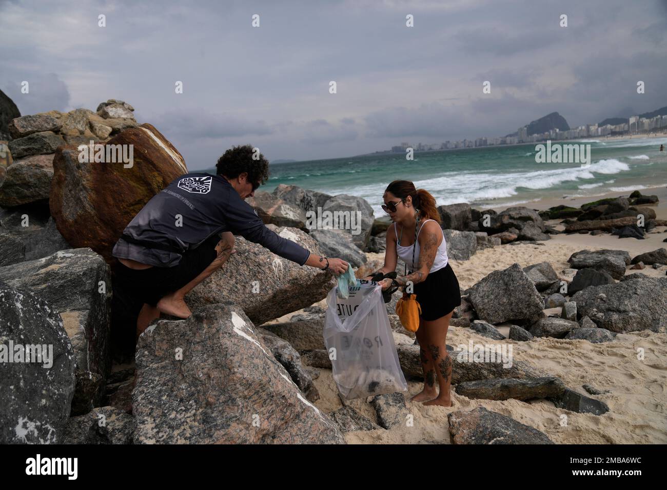 People pick up trash from Copacabana beach on World Oceans Day in Rio ...