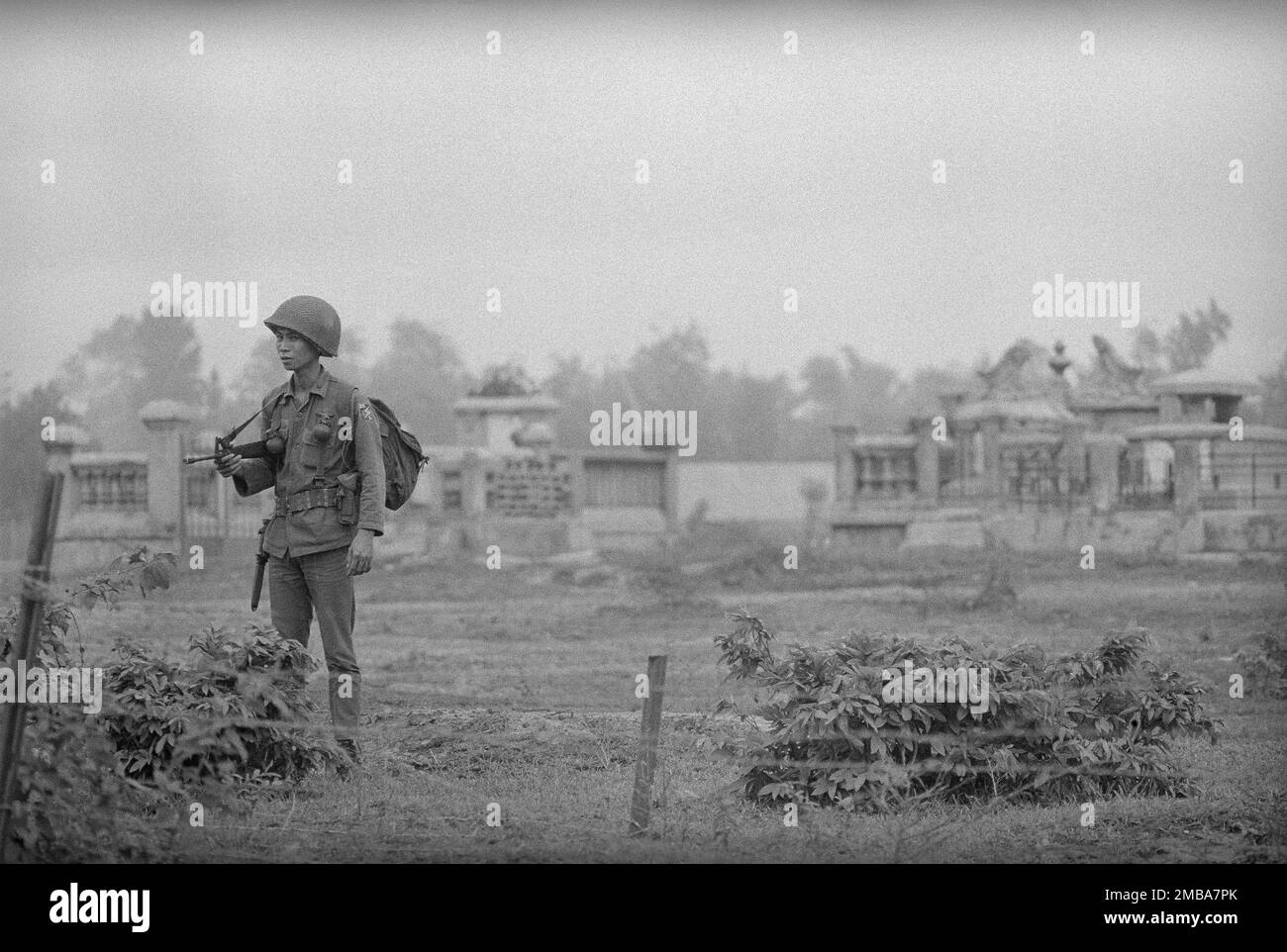A lone South Vietnamese soldier watches as bomb strikes are made on the ...