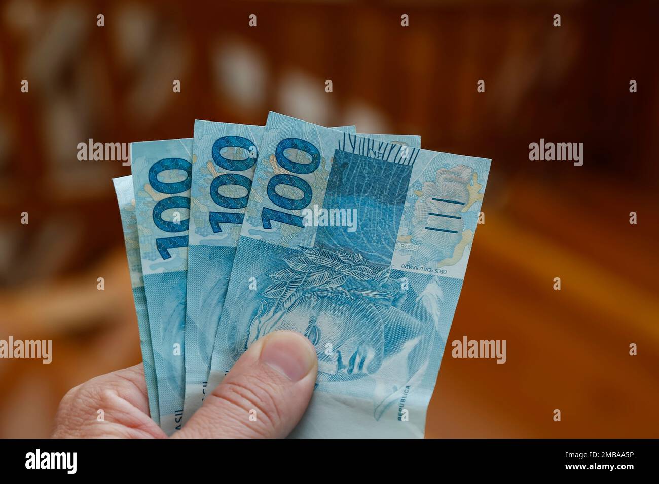 money from brazil stacked on dark wood surface - several hundred real ...