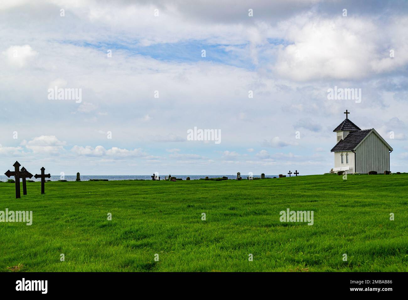 Church and cemetery with green grass by the coastline of Varhaug ...