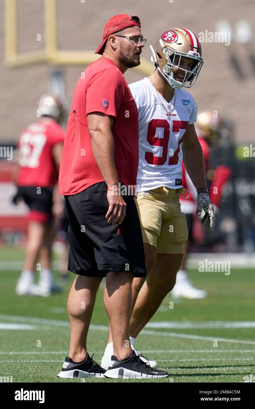 San Francisco 49ers defensive line coach Kris Kocurek, left, stands ...