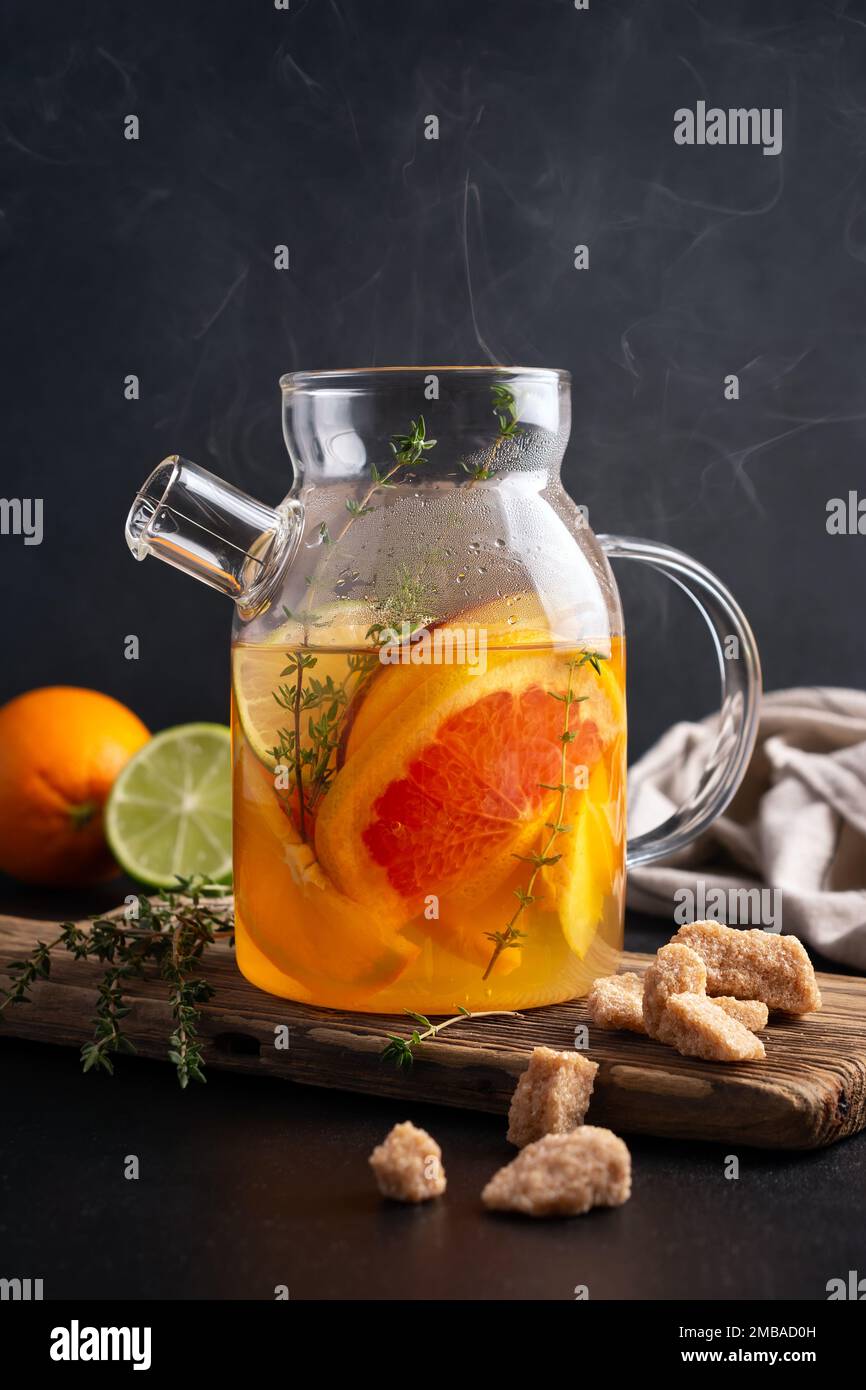 Homemade healthy hot fruit tea with fresh ripe orange, grapefruit, lime ...