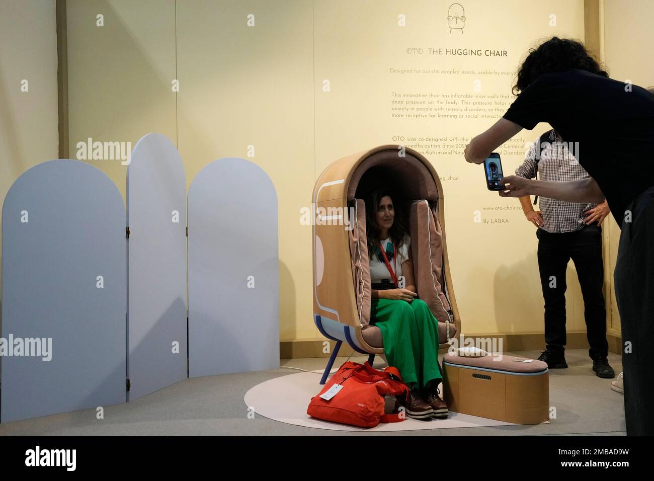 A man takes pictures of a woman sitting on a chair created by Oto's ...