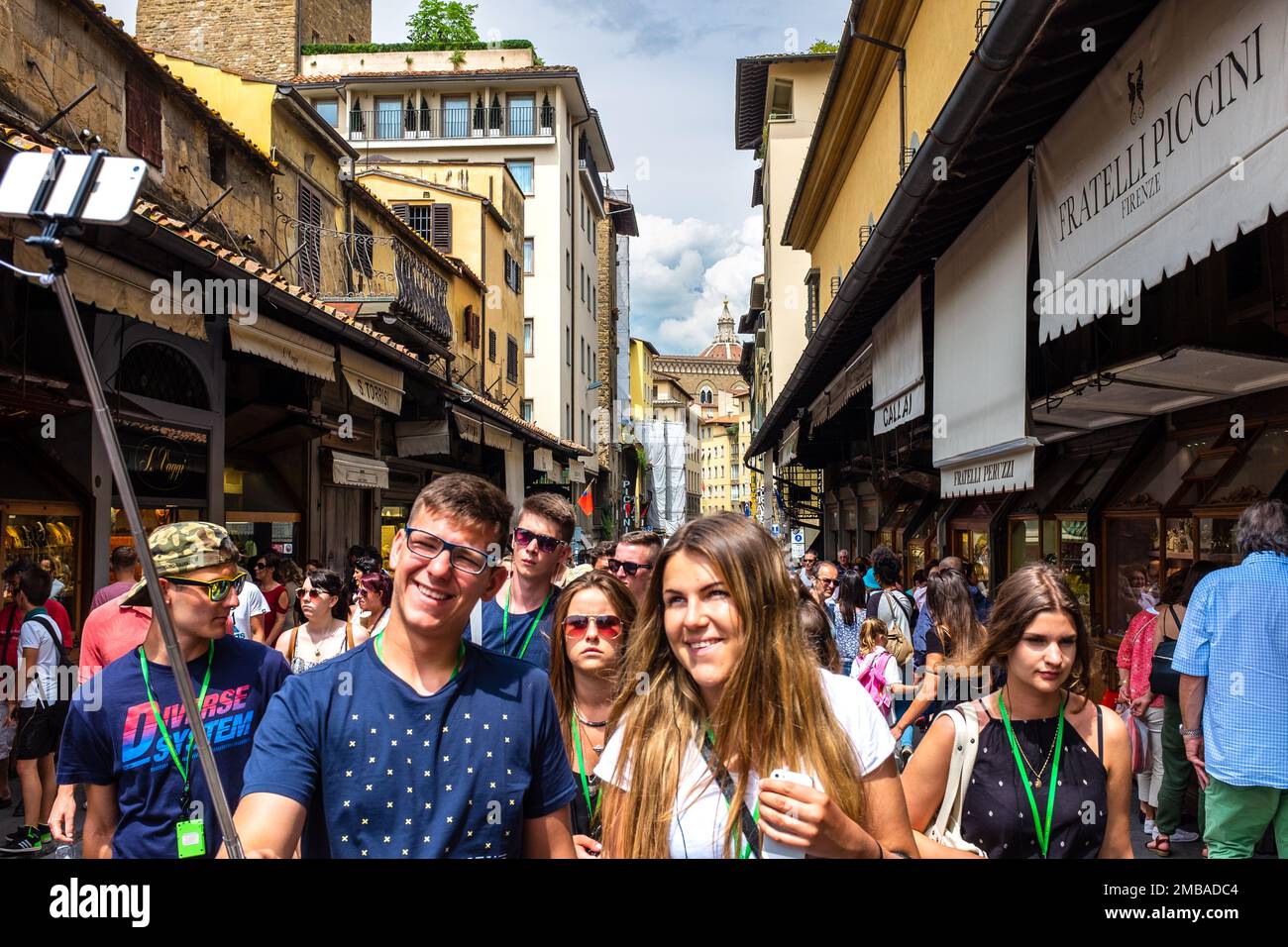 A young couple using a selfie stick to take a selfi in Florence ...