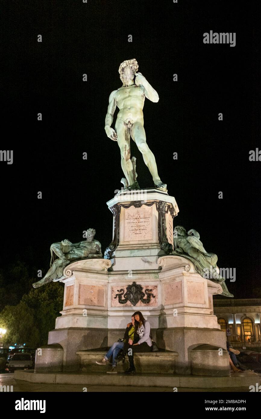 A young couple under the statue of David in Michelangelo's square ...