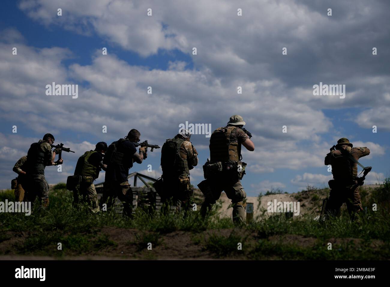 Civilian militia men hold rifles during training at a shooting range in ...