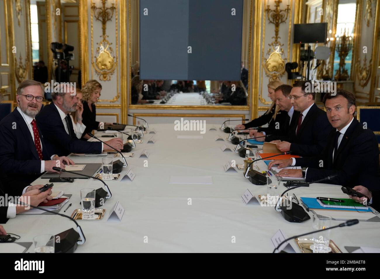 French President Emmanuel Macron, right, attends a meeting with the ...