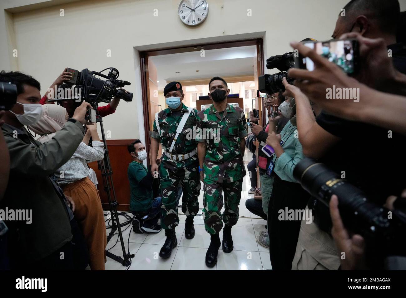 Colonel Priyanto, a mid rank army officer, center, walks in a courtroom ...