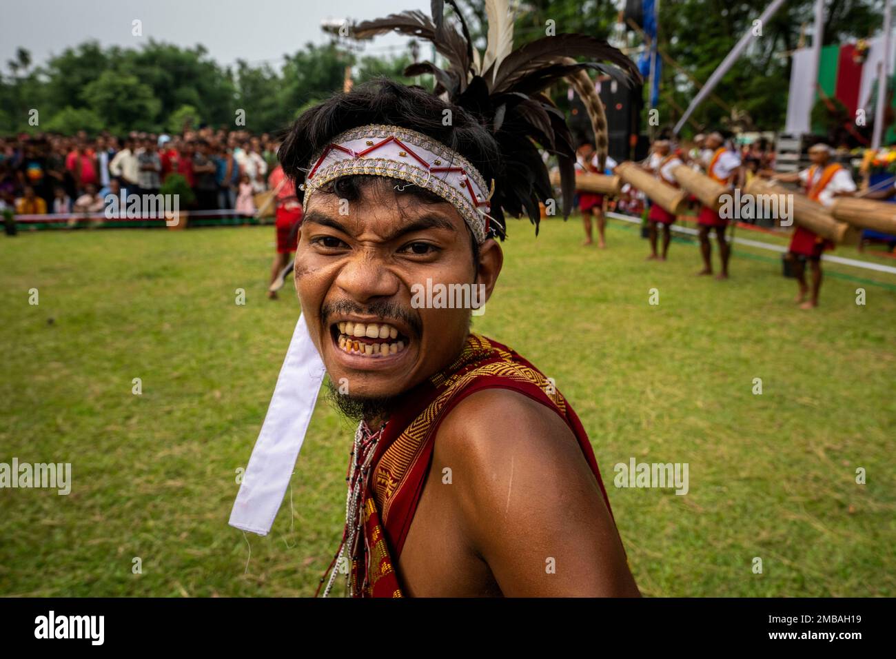 An Indian Garo tribal in traditional attire performs a traditional ...