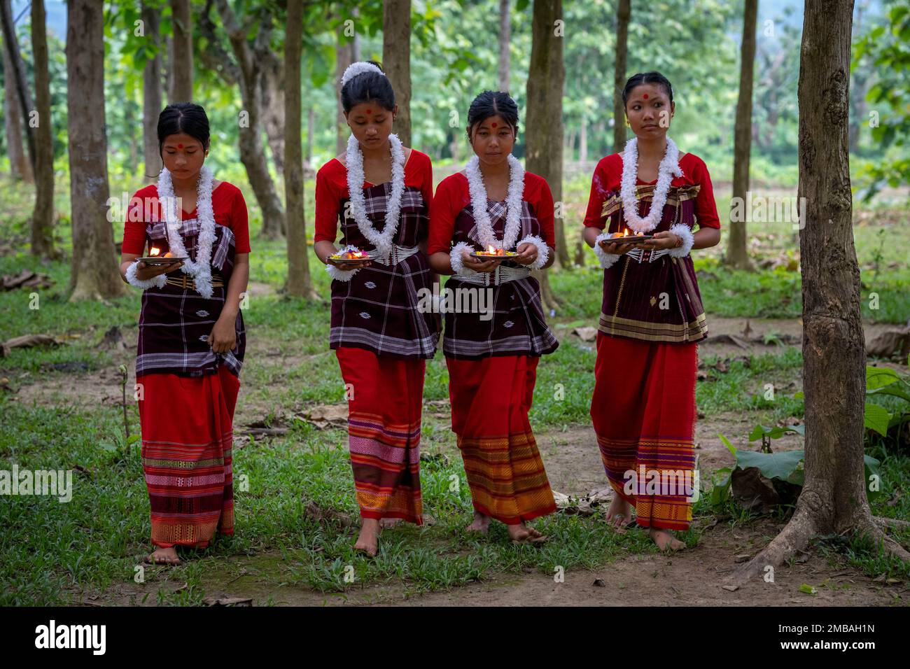 Indian Rabha tribal girls in traditional attire bring offerings before ...