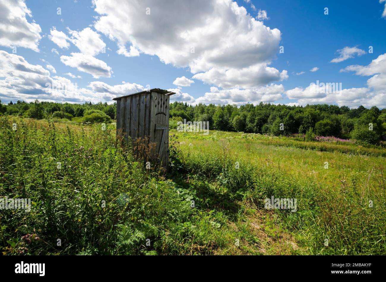 Rustic toilet in a green field Stock Photo - Alamy