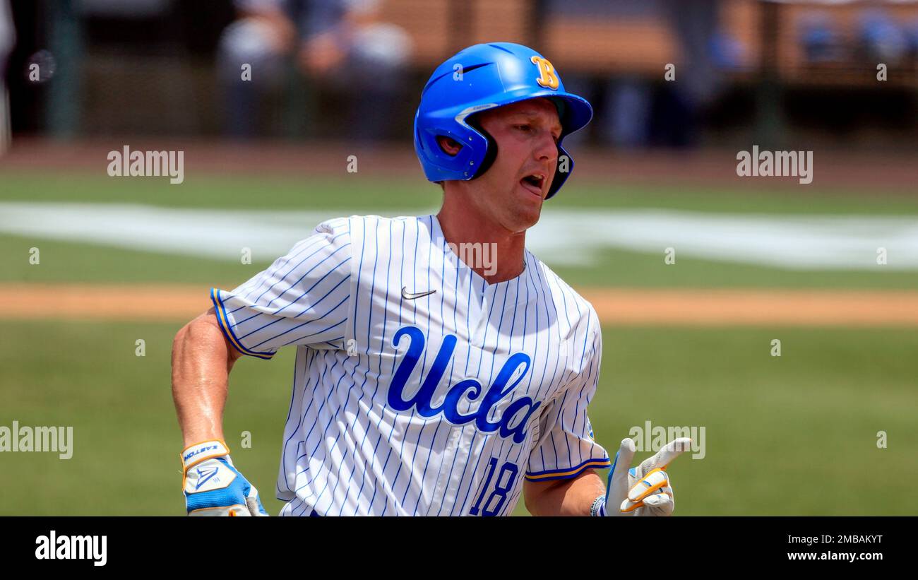 UCLA batter Carson Yates (18) runs to first during an NCAA baseball ...