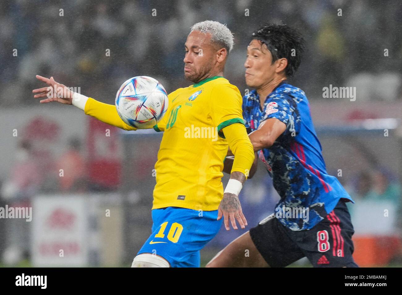 Neymar of Brazil, left, fights for the ball against Genki Haraguchi of ...