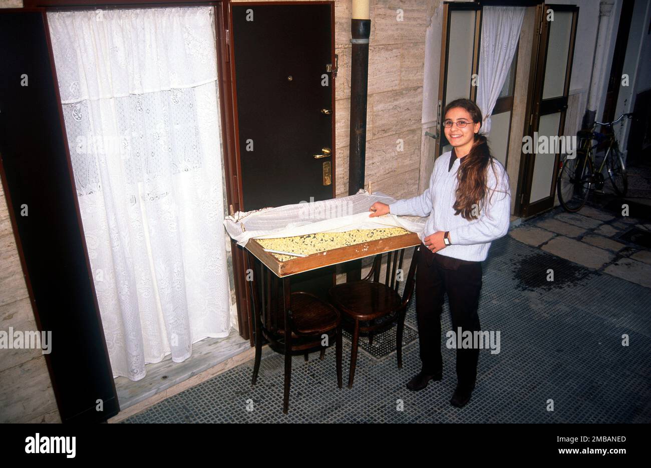 Italy Apulia Bari Historic center, girl on the doorstep shows the ...