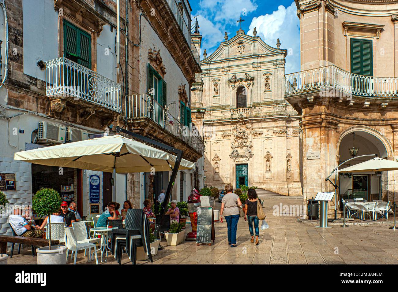 Italy Apulia Valle D'Itria Martina Franca People in square and basilica ...
