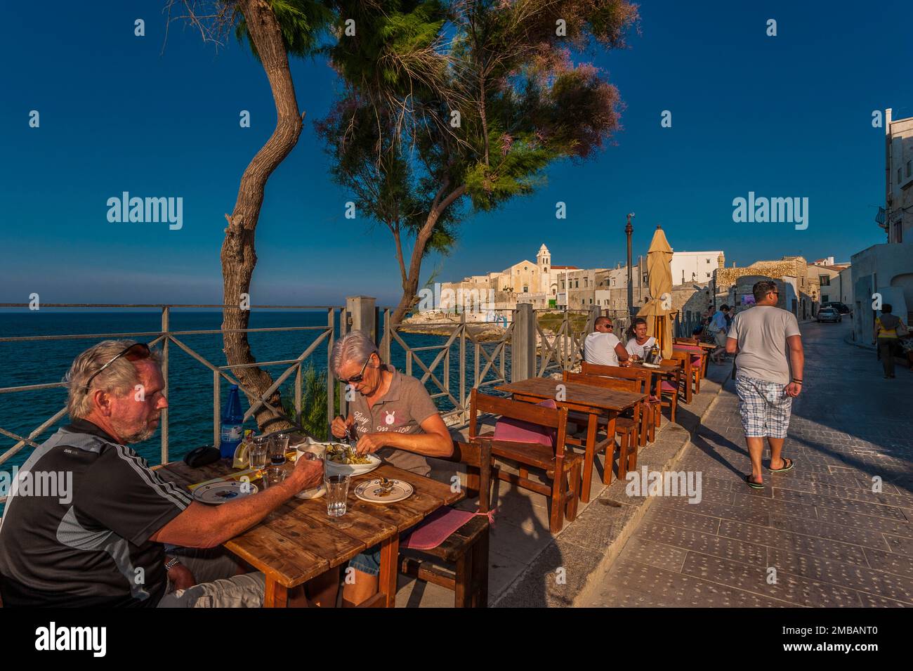 Italy Apulia Gargano Vieste - people sitting at the table of restaurant ...