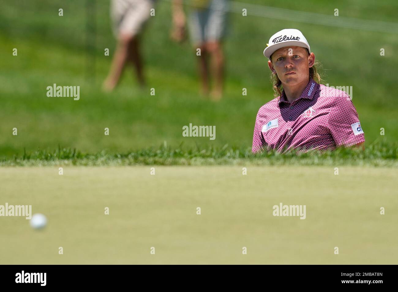 Cameron Smith, of Australia, watches his chip shot roll on the first ...