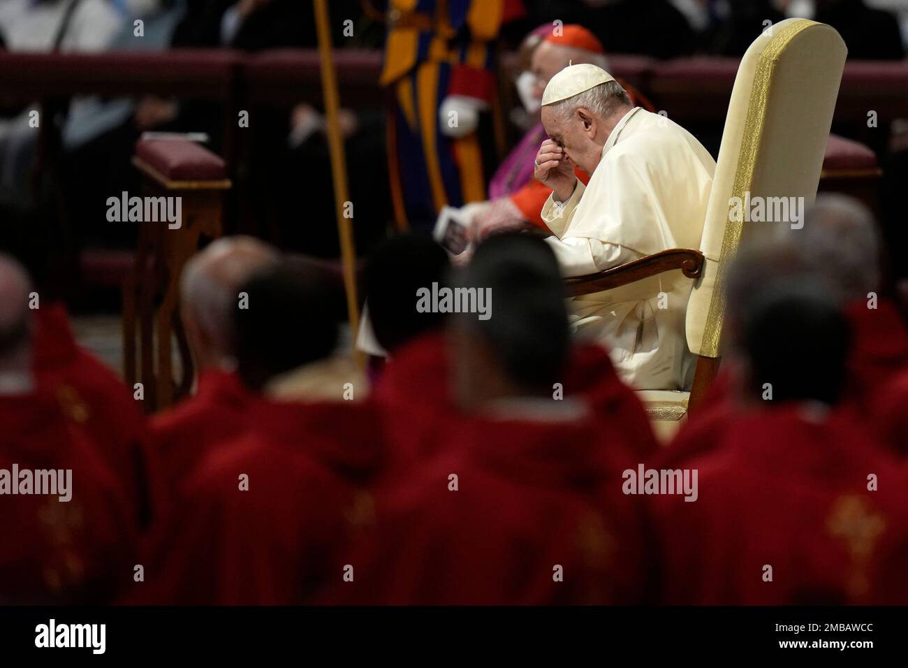 Pope Francis puts his hand to his face as he attends a Pentecost Mass ...