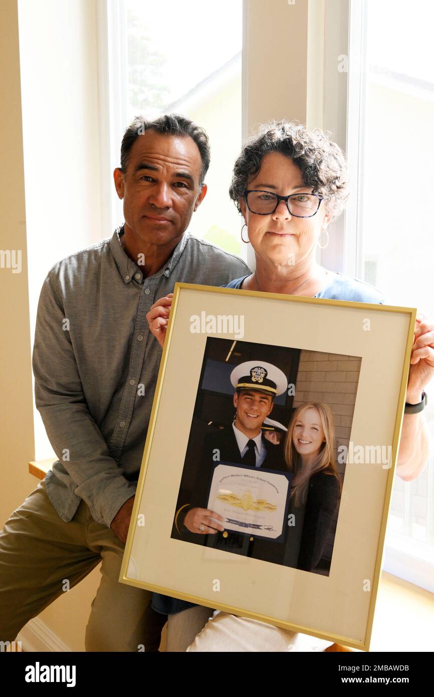 Derek and Suzi Alkonis pose with a photo of their son Lt. Ridge Alkonis ...