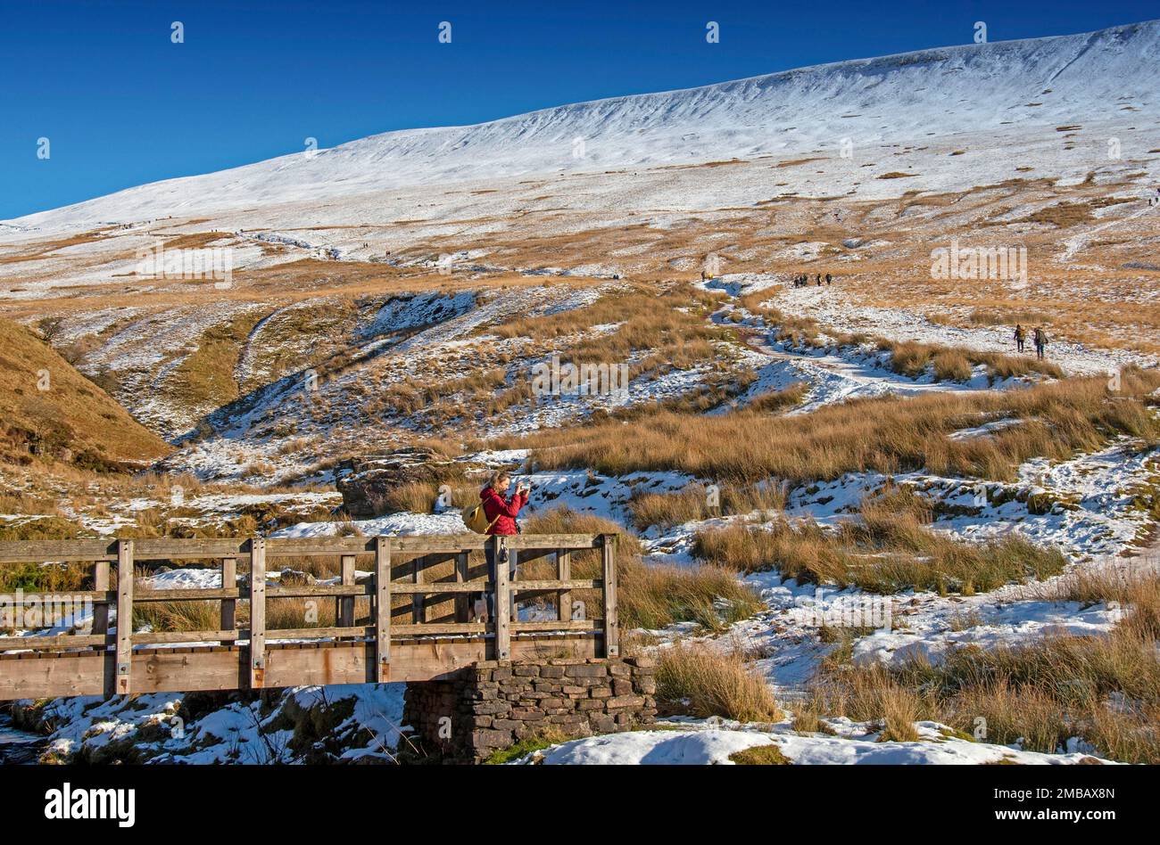 Brecon, UK. 20th Jan, 2023. People make their way across the wooden ...